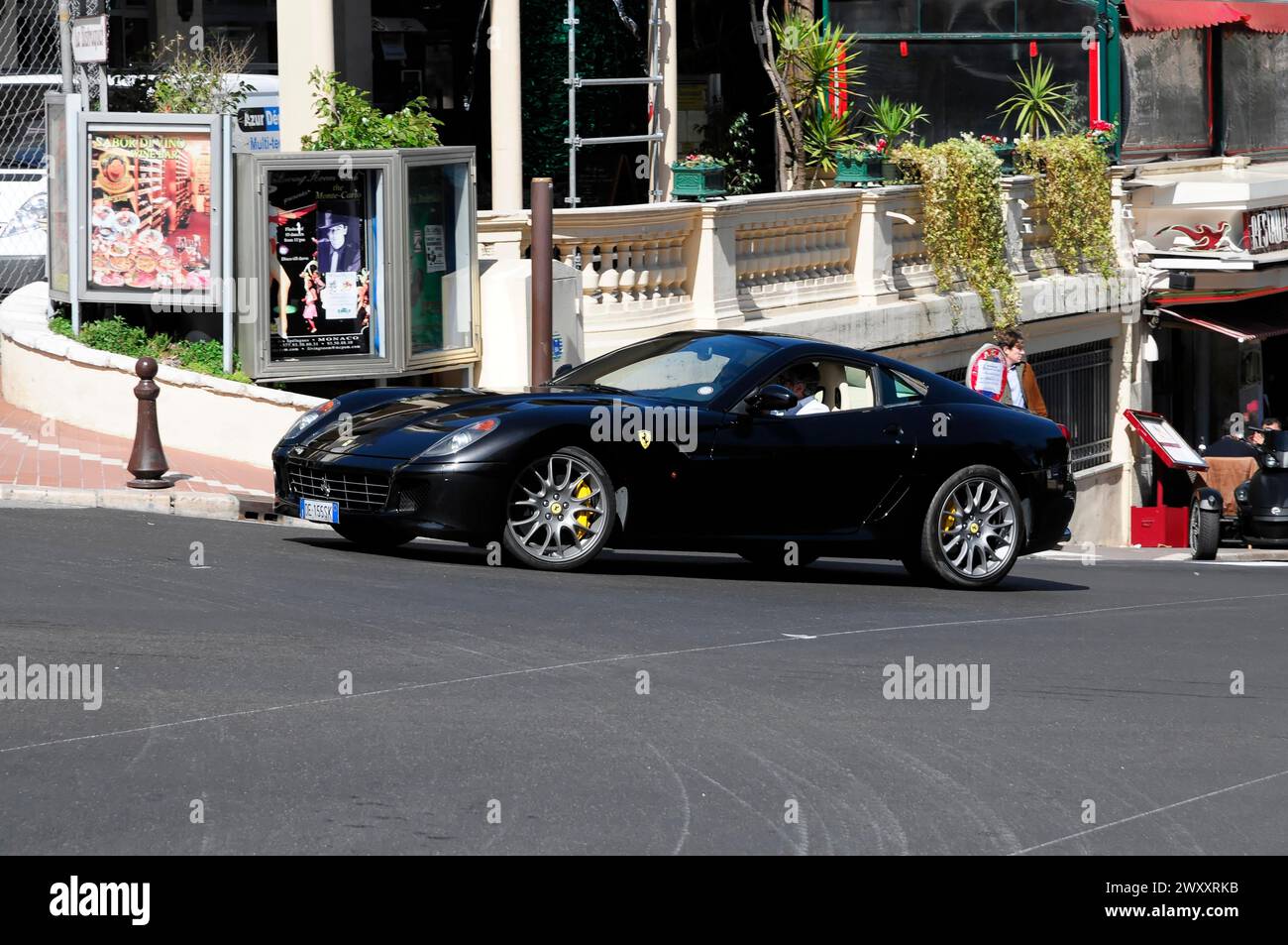 A black Ferrari parked on the roadside in the city centre, Monte Carlo ...