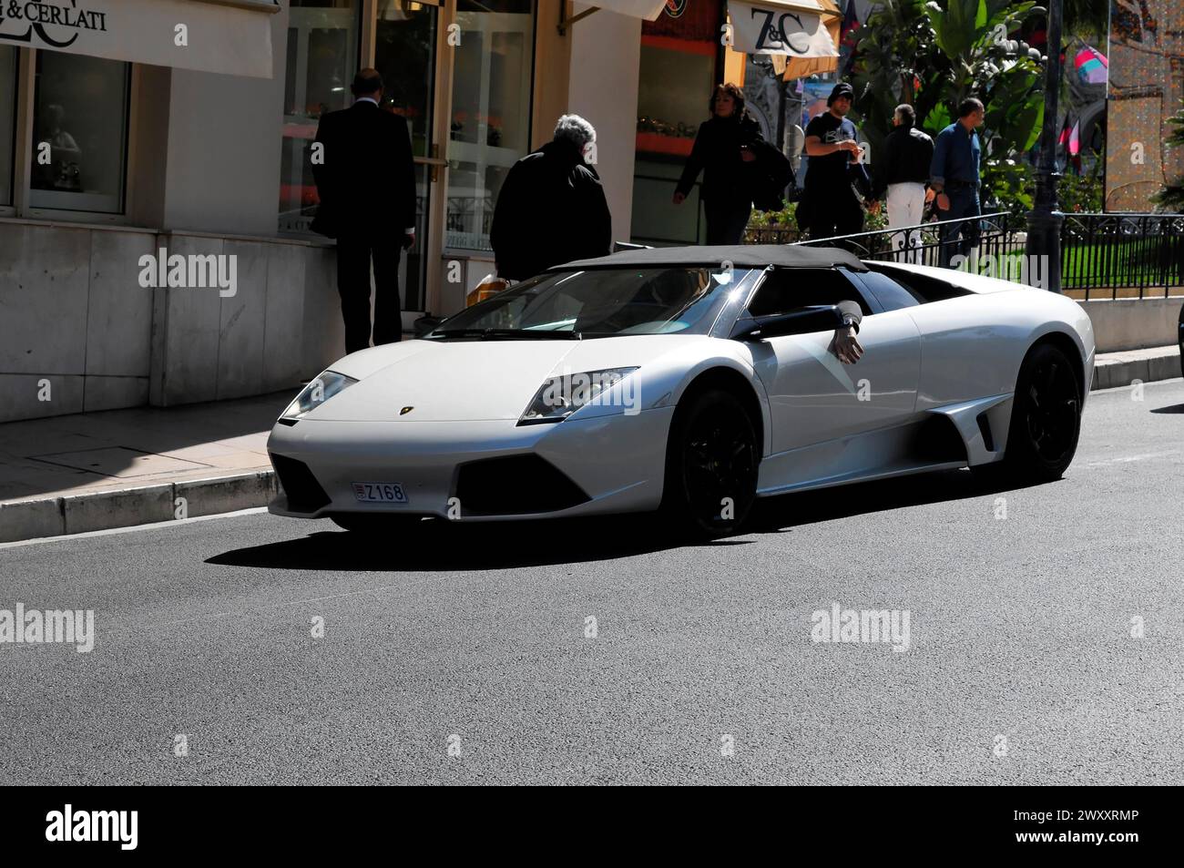 A white Lamborghini driving on a busy city street, Monte Carlo ...
