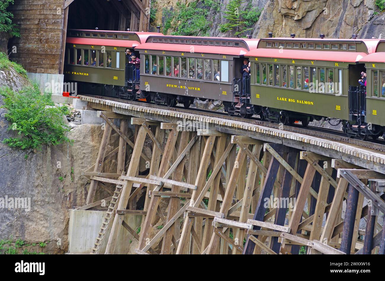 Historic railway carriages on an old wooden bridge, White Pass Railway ...
