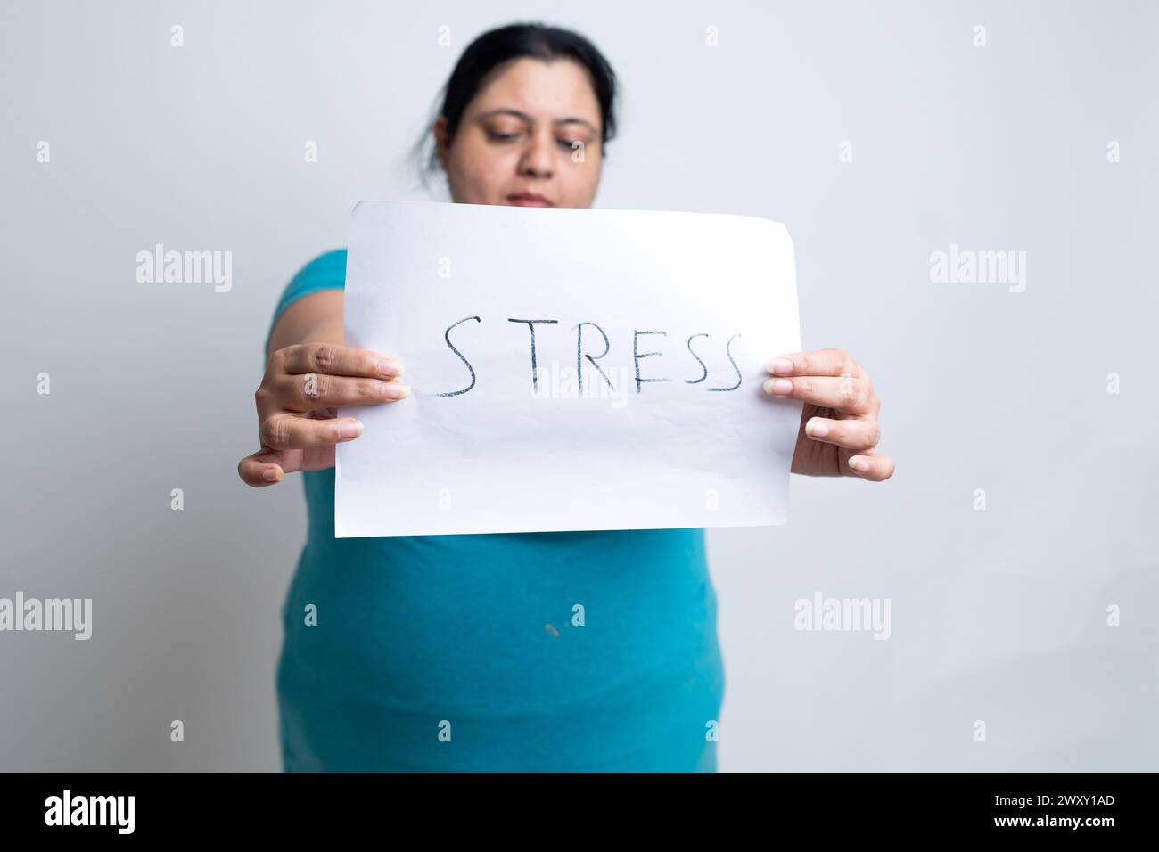 Overweight fat indian woman holding white paper written stress ...