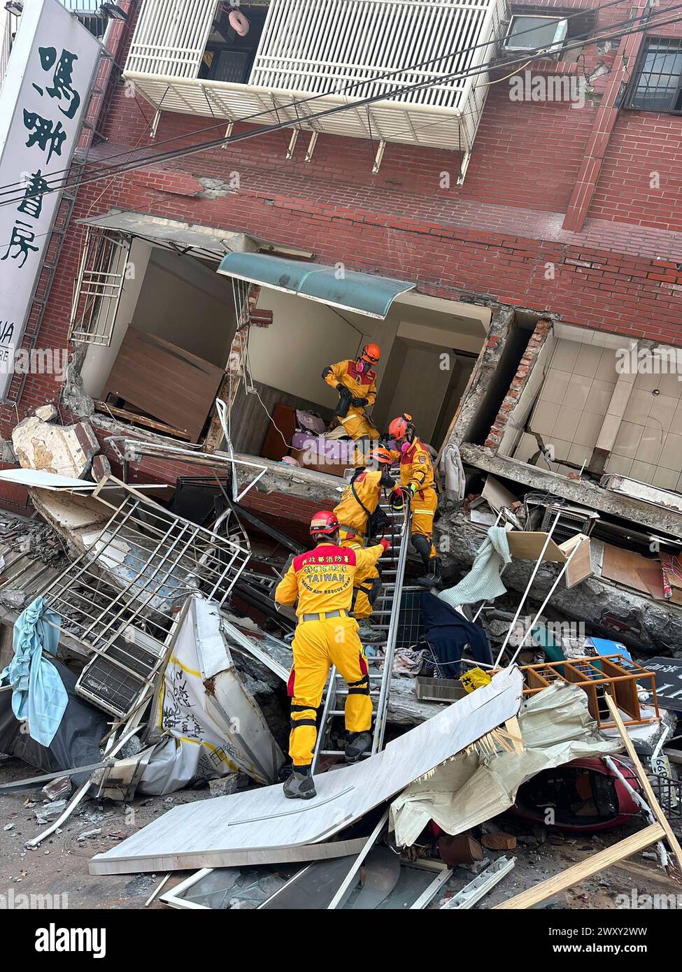 In this photo released by the National Fire Agency, members of a search ...