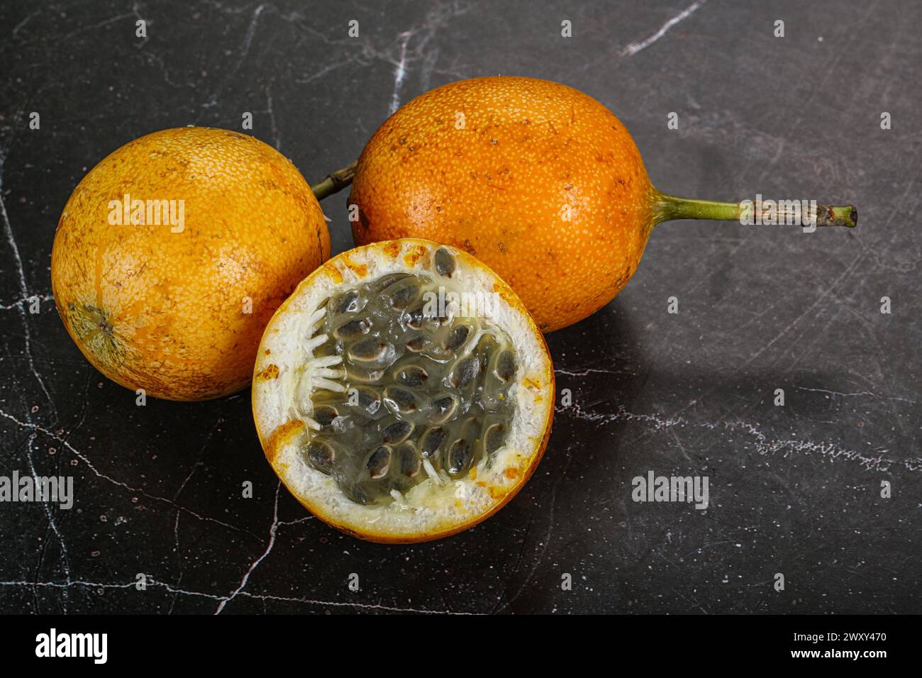Tropical juice Granadilla Passion fruit slice Stock Photo - Alamy
