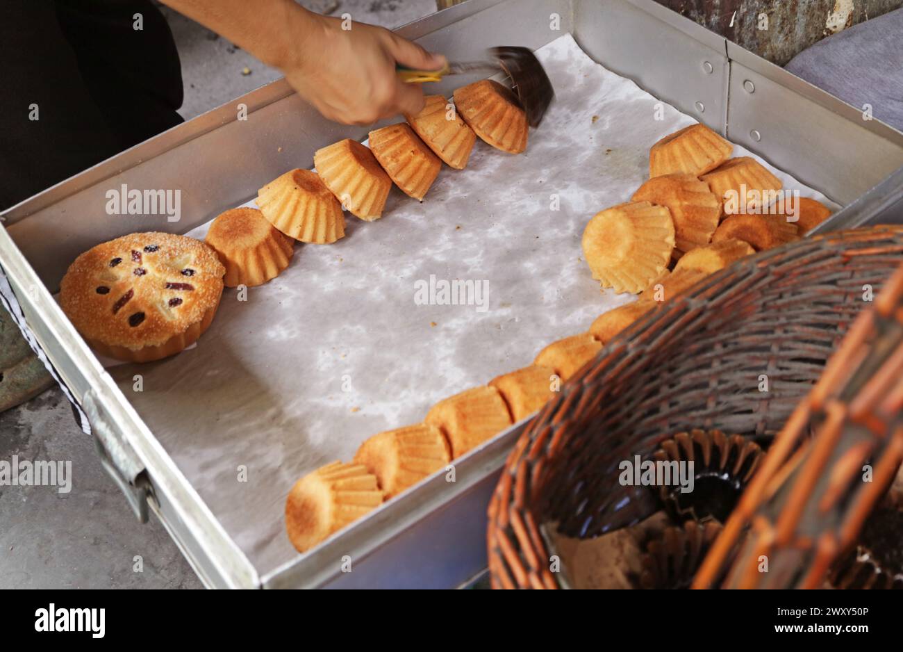 Baker Removing Heap of Freshly Baked Portuguese-Siamese Kudeejeen ...