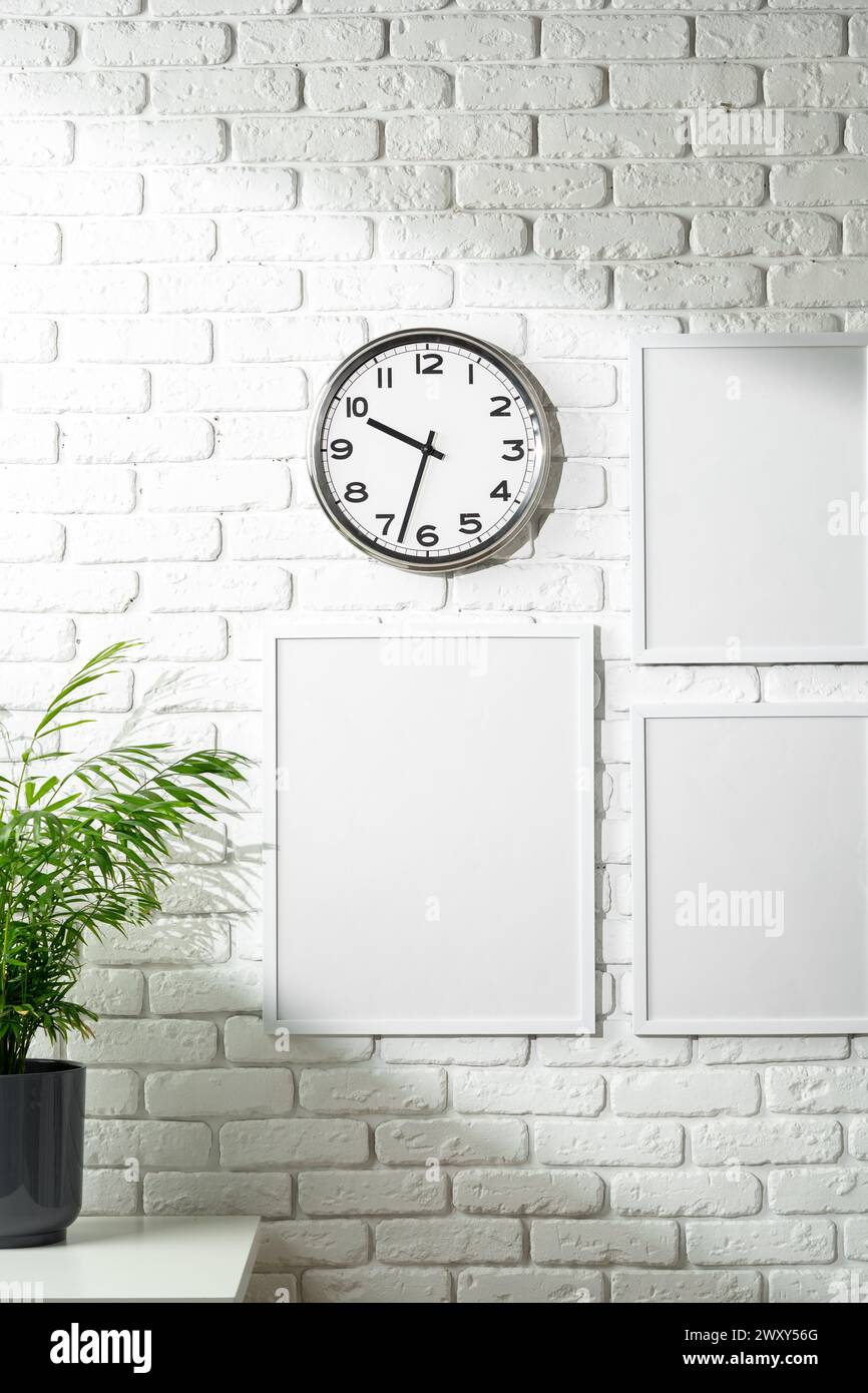 Minimalist White Wall Display With Clock and Empty Frames in a Modern ...