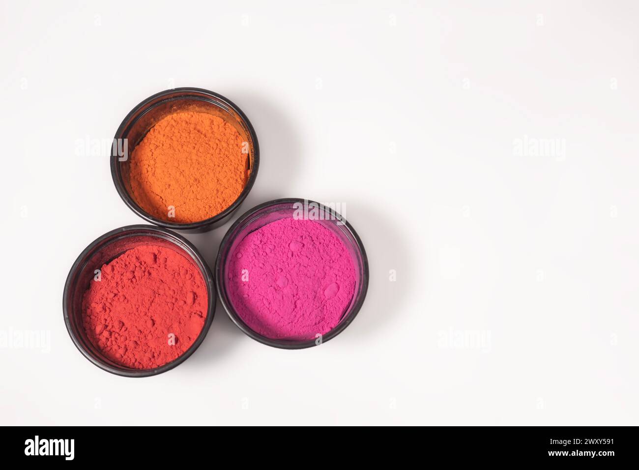 Multicolored Holi powder in plastic box on white background. Indian ...