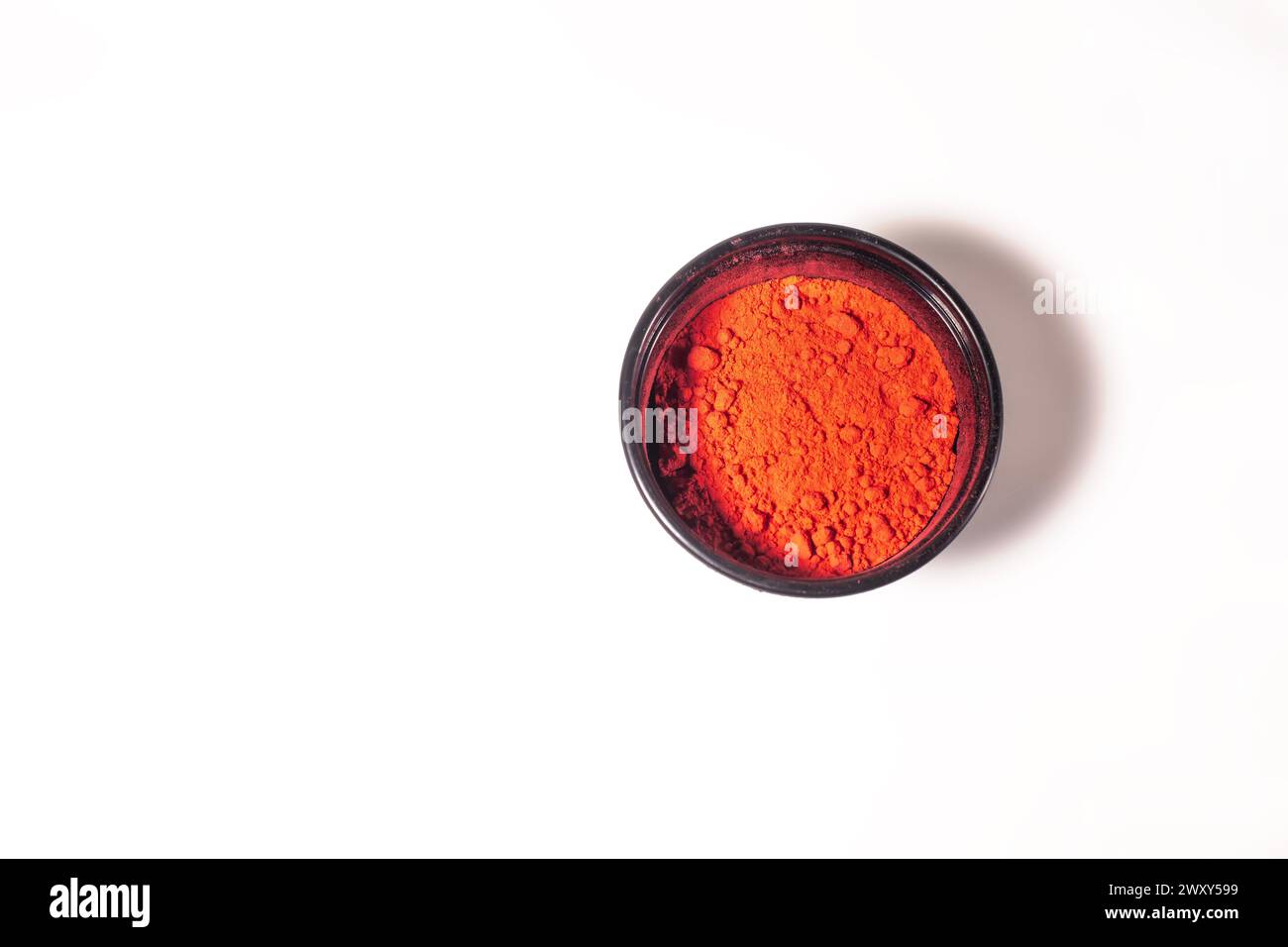 Top view of red holi powder in plastic box on white background for ...