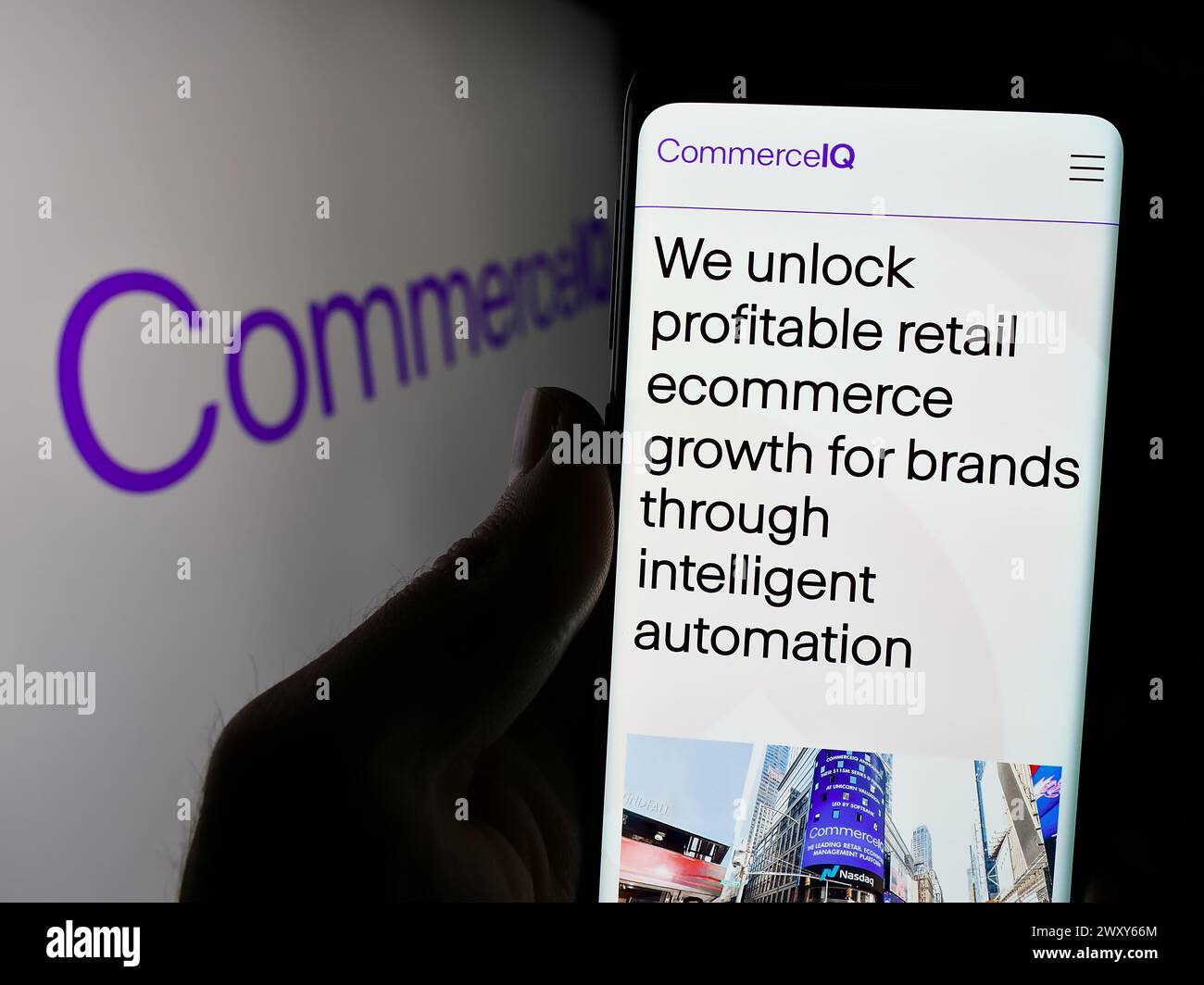 Person holding cellphone with webpage of US e-commerce management ...