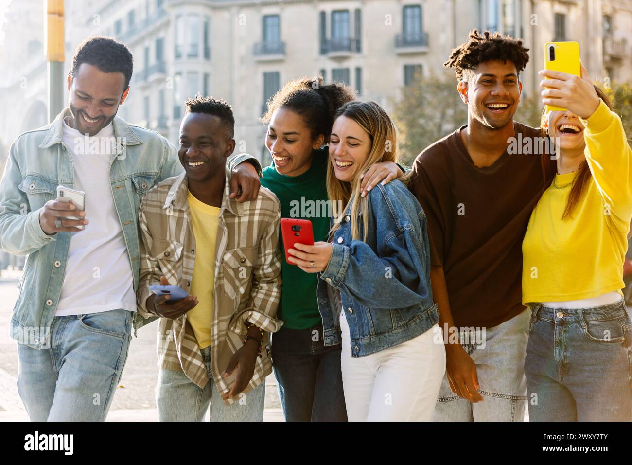 Happy friends with mobile phones enjoying social moments at city street ...