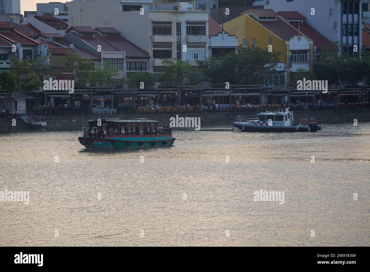 Police coast guard vessel patrolling at Singapore River, a bum boat ...