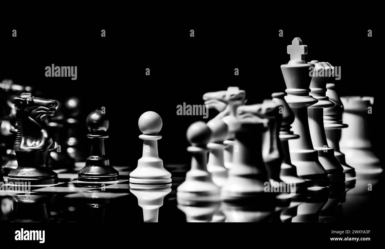 Close up of Chess pieces on a reflective mirror board surface with a ...