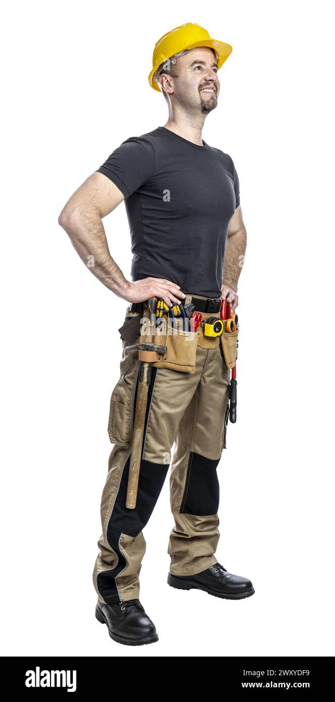 Confident construction worker stands with hands on hips, wearing a hard ...