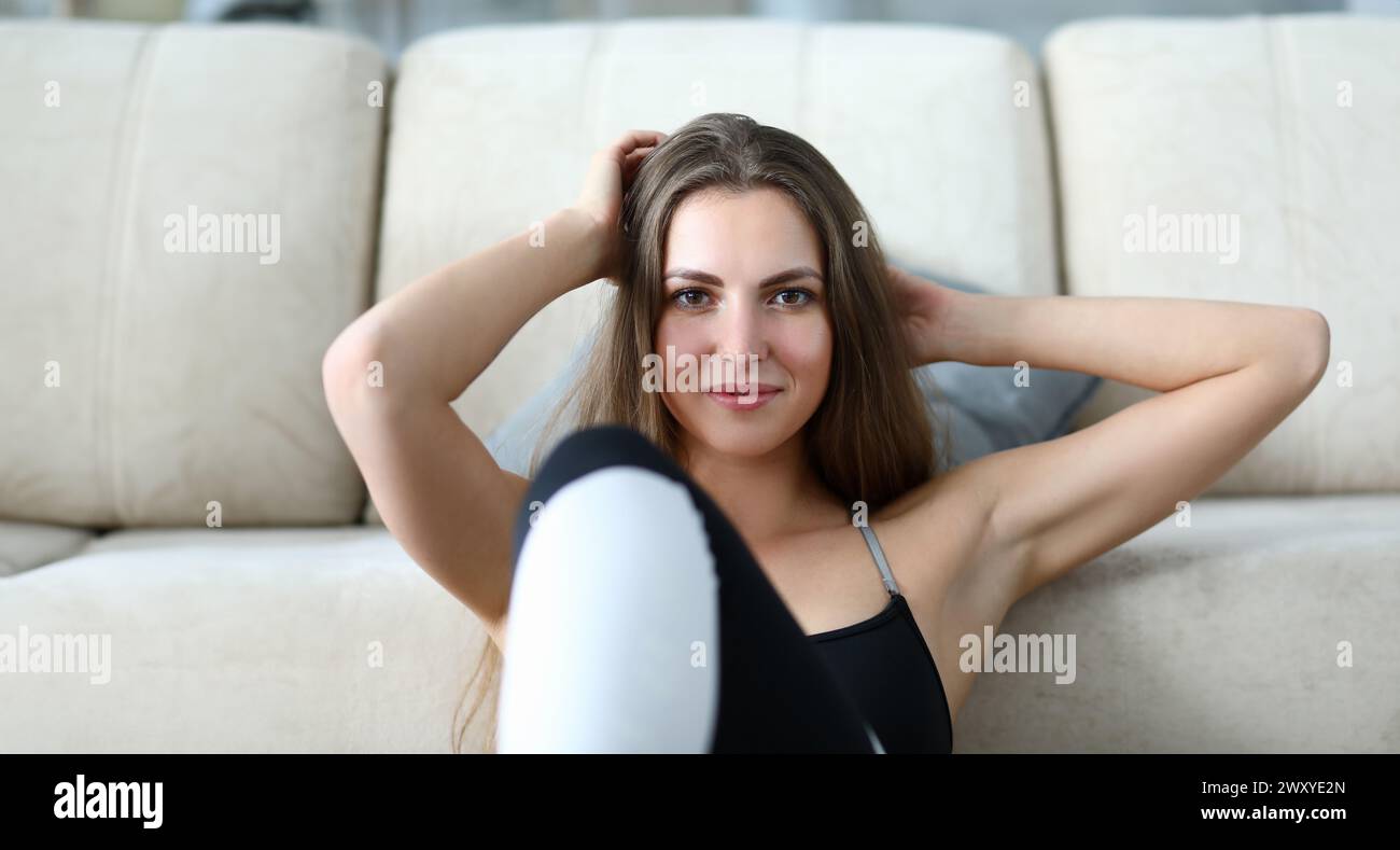 Girl lies with her hands behind her head, exercise Stock Photo - Alamy