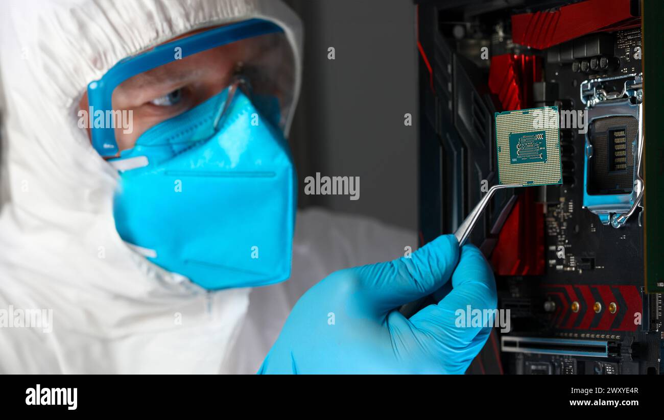 Male engineer install microprocessor in fast computer Stock Photo - Alamy