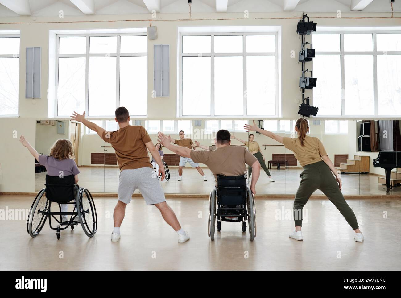 Rear view of four diverse men and women practicing dance with ...