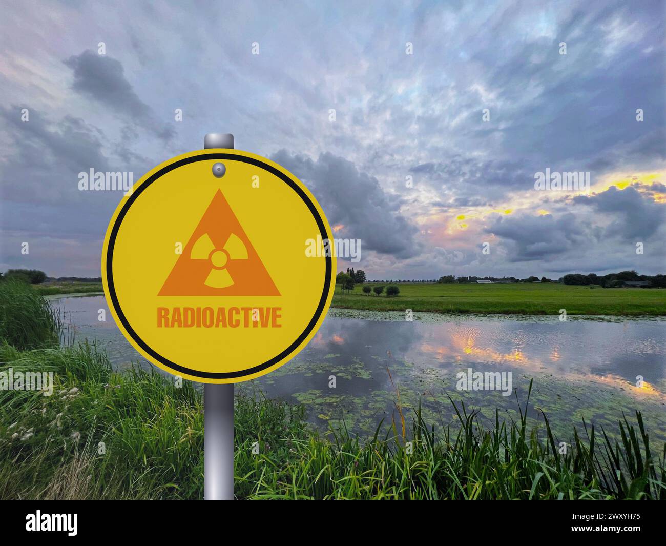 Radioactive pollution. Yellow warning sign with hazard symbol near lake ... Radioactive pollution. Yellow warning sign with hazard symbol near lake ...