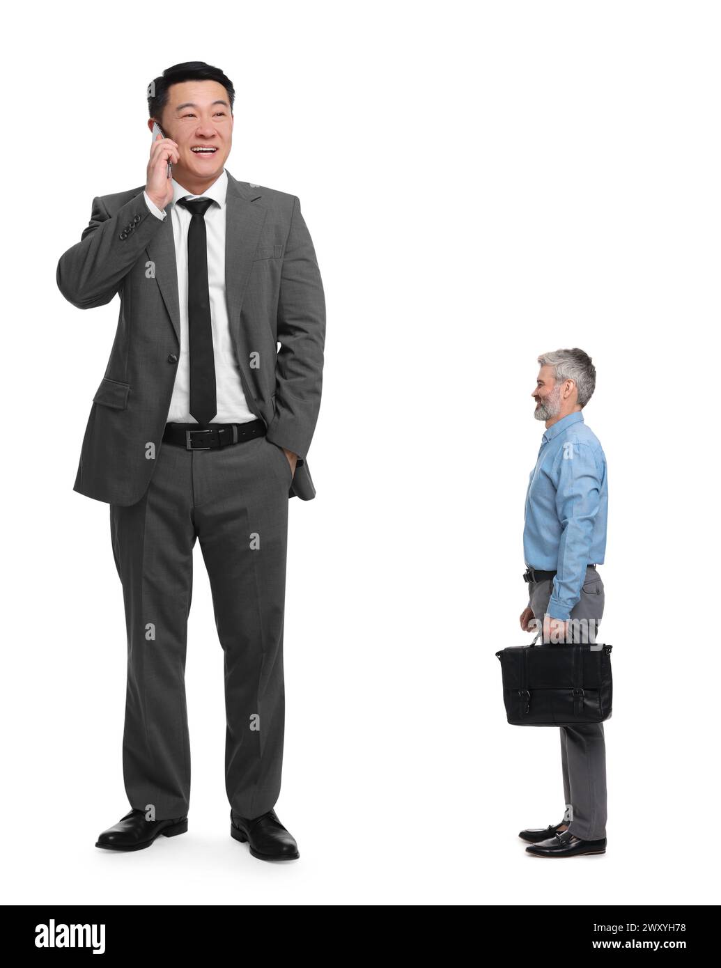 Giant boss and small man on white background Stock Photo - Alamy