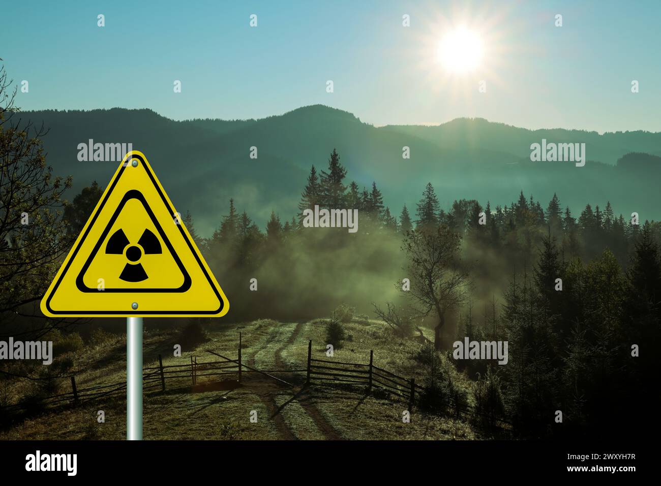 Radioactive pollution. Yellow warning sign with hazard symbol in ...