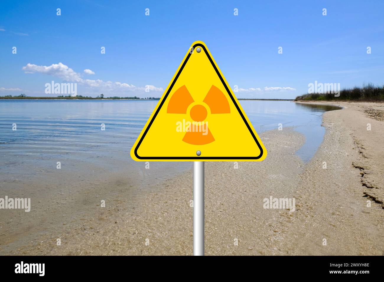 Radioactive pollution. Warning sign with hazard symbol near sea side ...