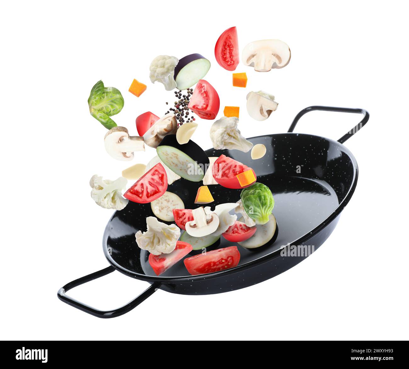 Frying pan with fresh ingredients in air on white background Stock ...