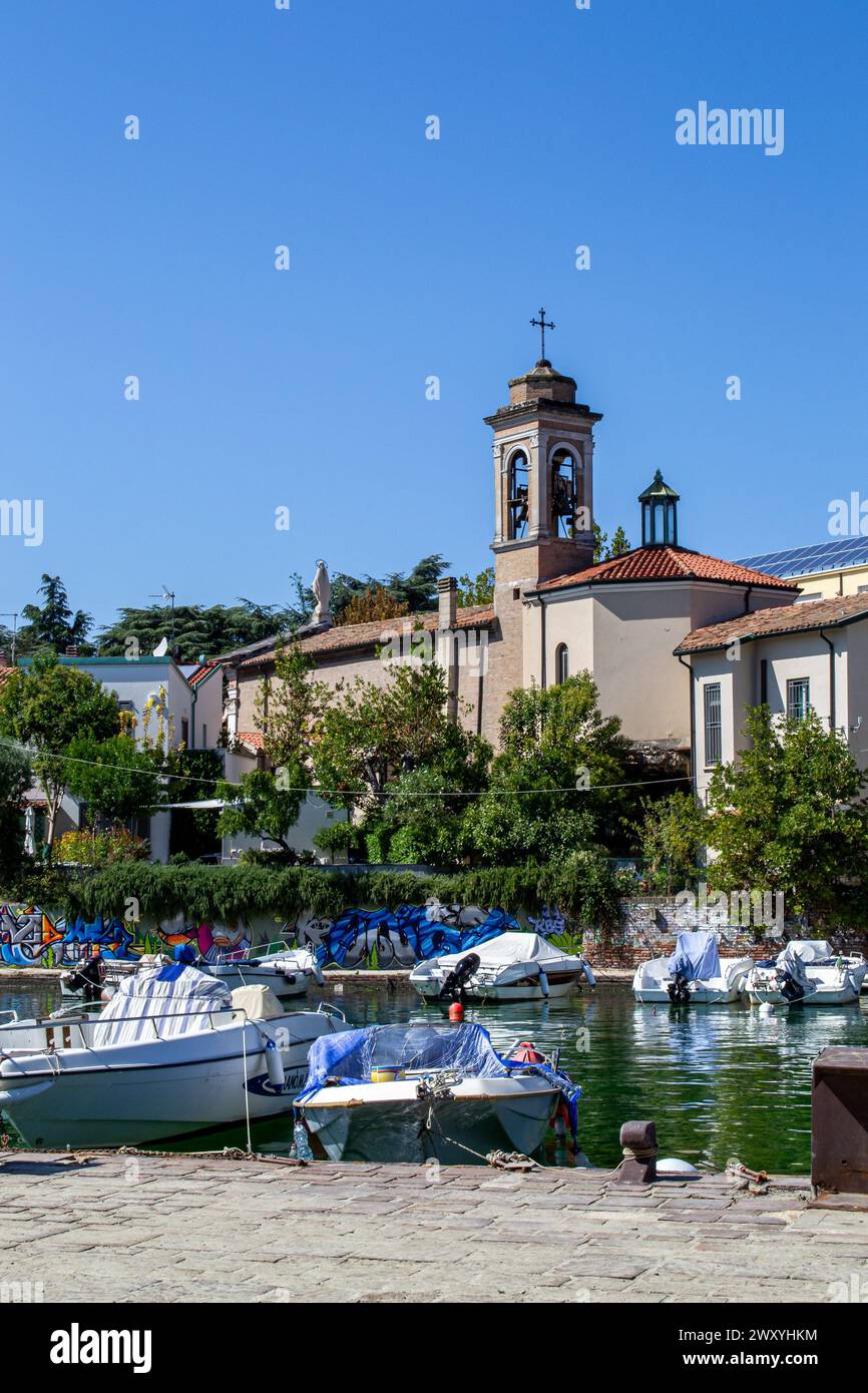 View of the Italian church and canal with boats Stock Photo - Alamy