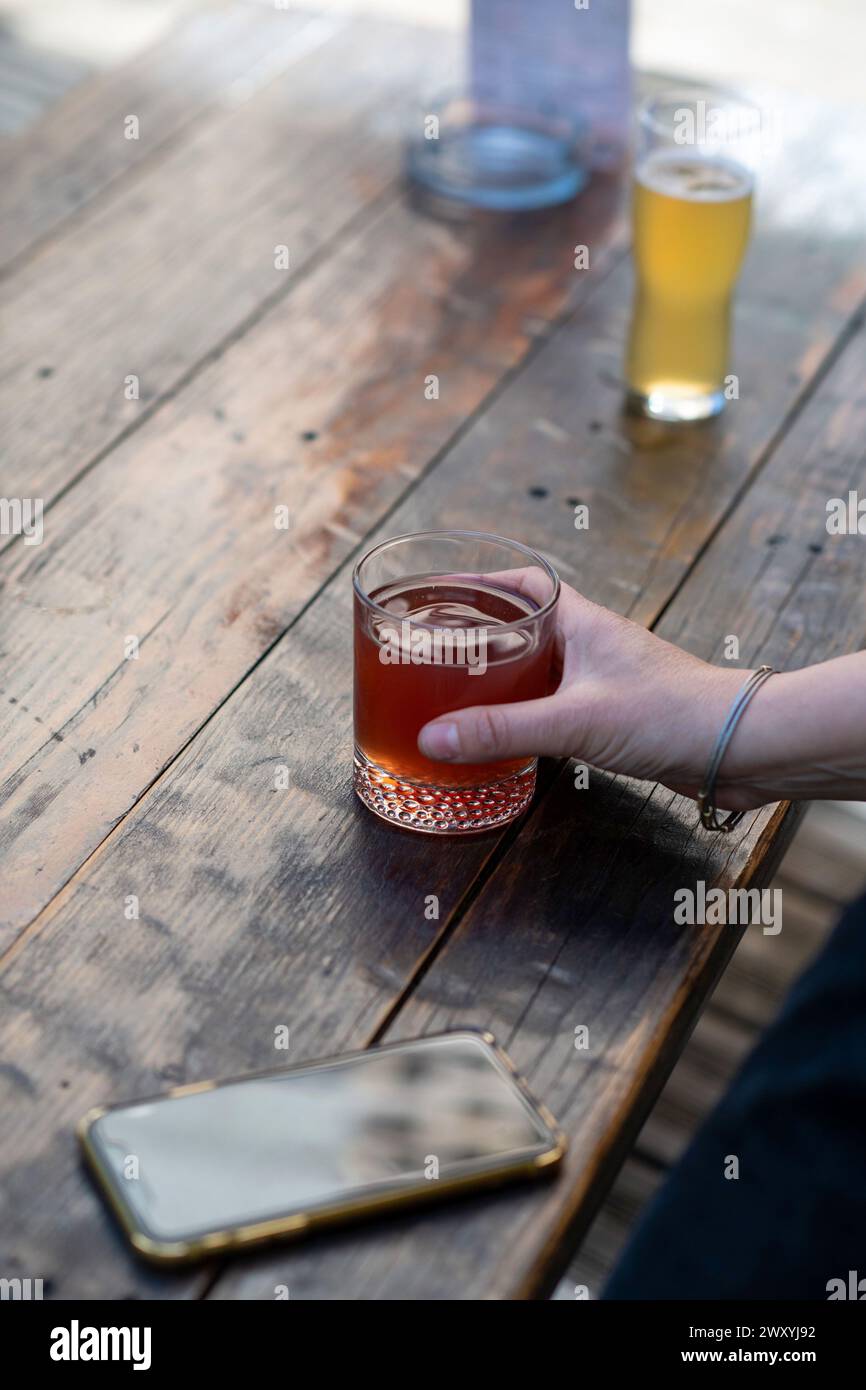 Aperitif, drinks, drinking alcohol with friends. Hands of woman ...