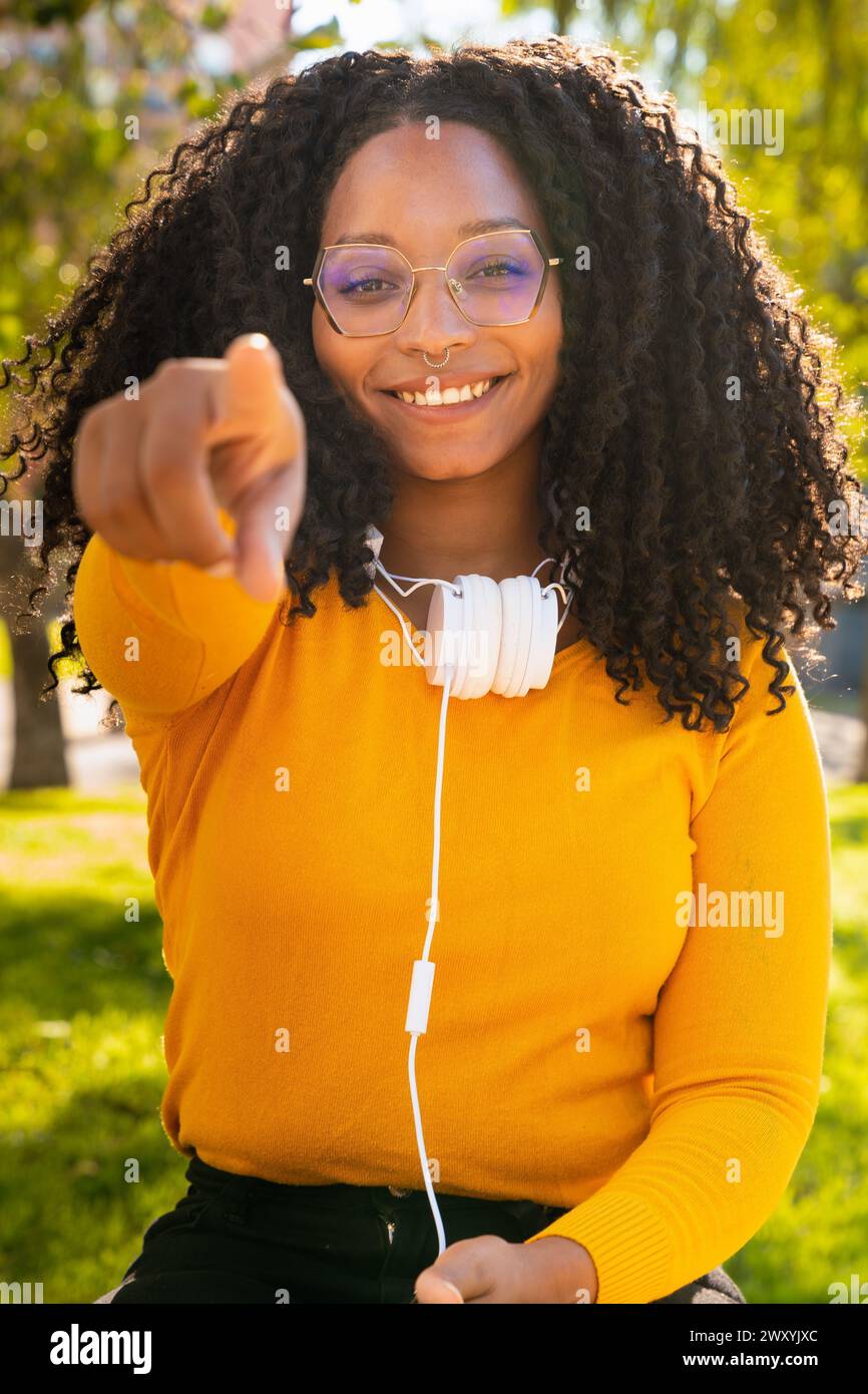 Vertical portrait African American woman pointing thumb forward Stock ...