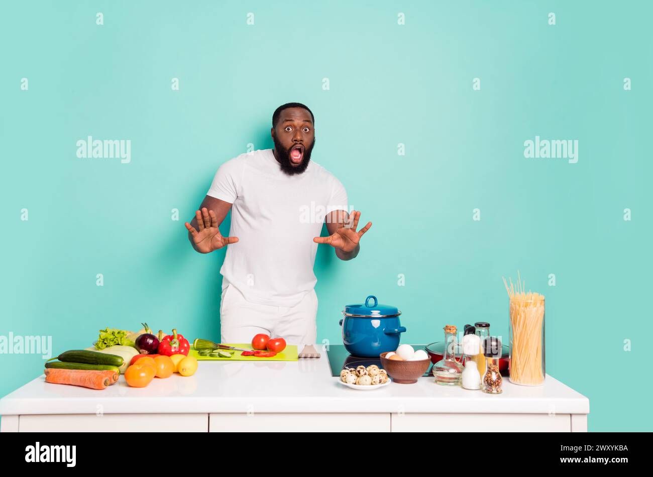 Photo of scared funky man wear white t-shirt afraid cooking food ...
