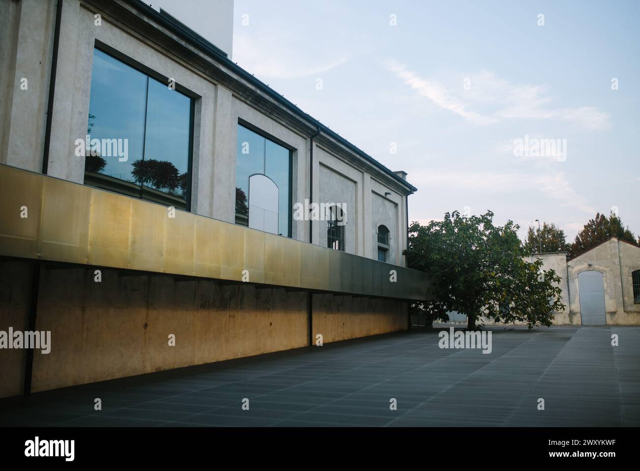 A contemporary building facade displaying a mix of materials, with ...