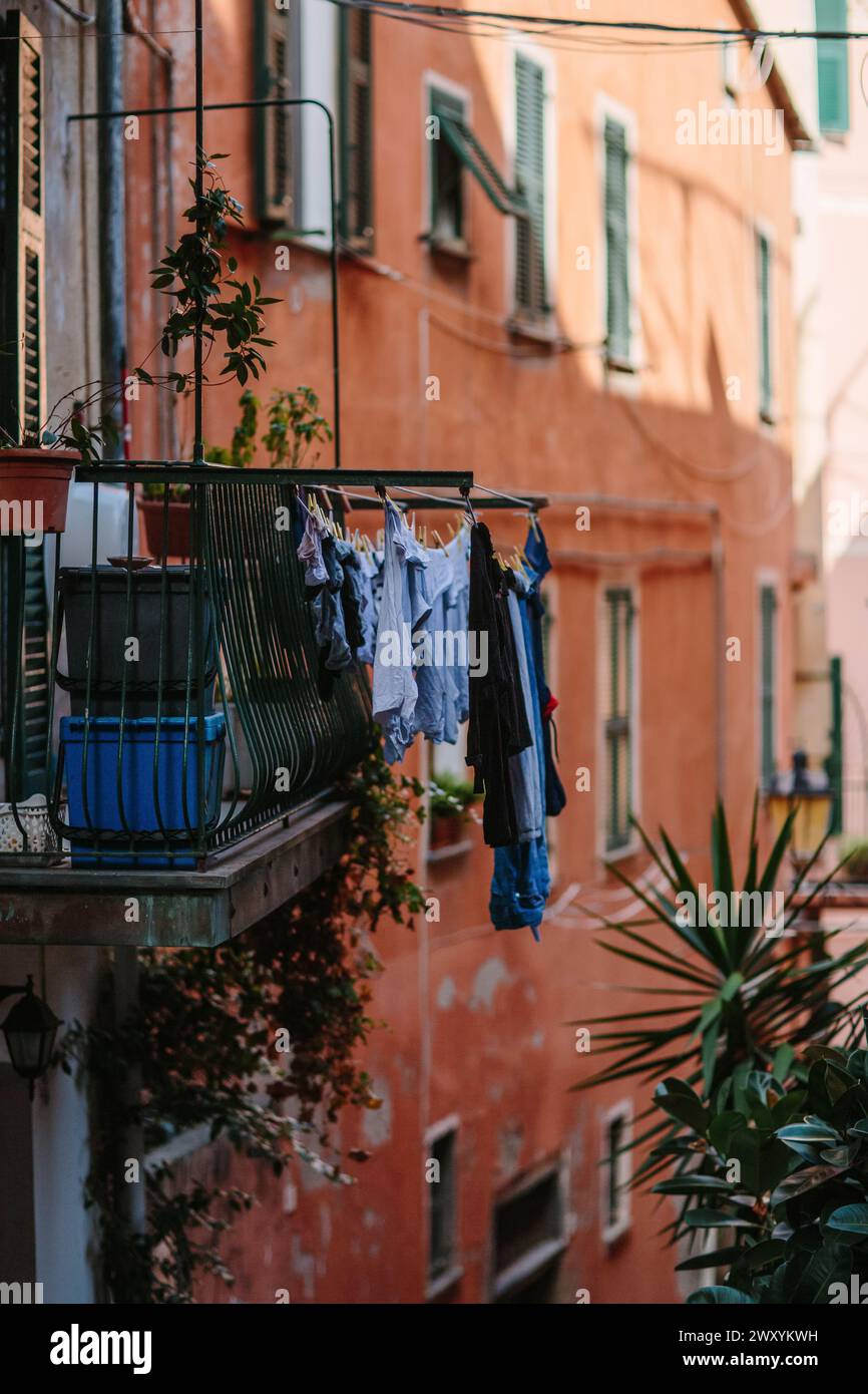 Laundry hangs from a balcony clothesline against the backdrop of warm ...