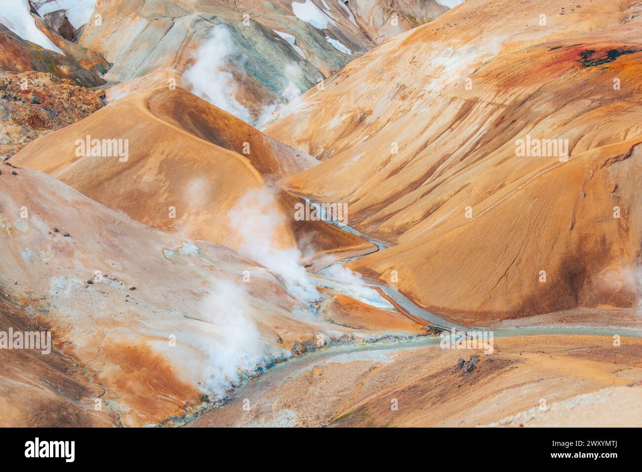 Steam rises from geothermal hot springs at the colorful rhyolite ...
