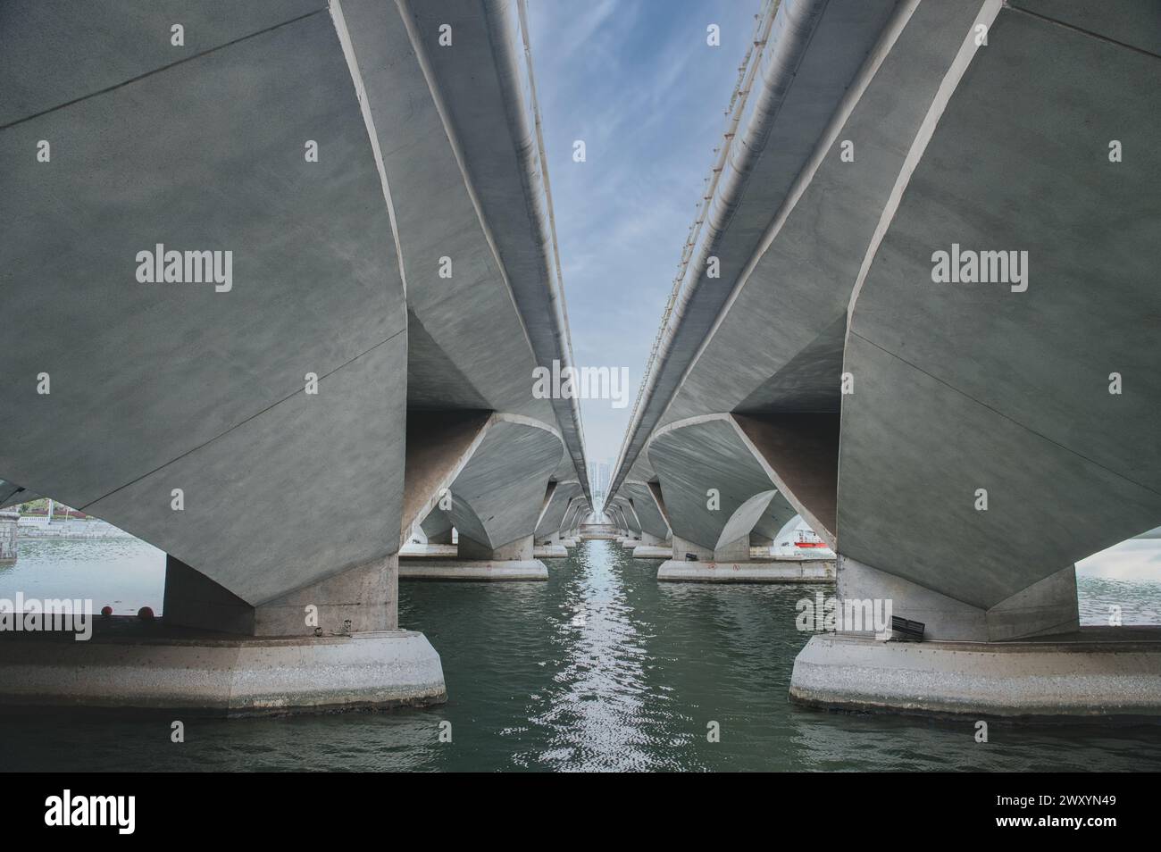Symmetric underbelly view of a modern concrete bridge showcasing the ...