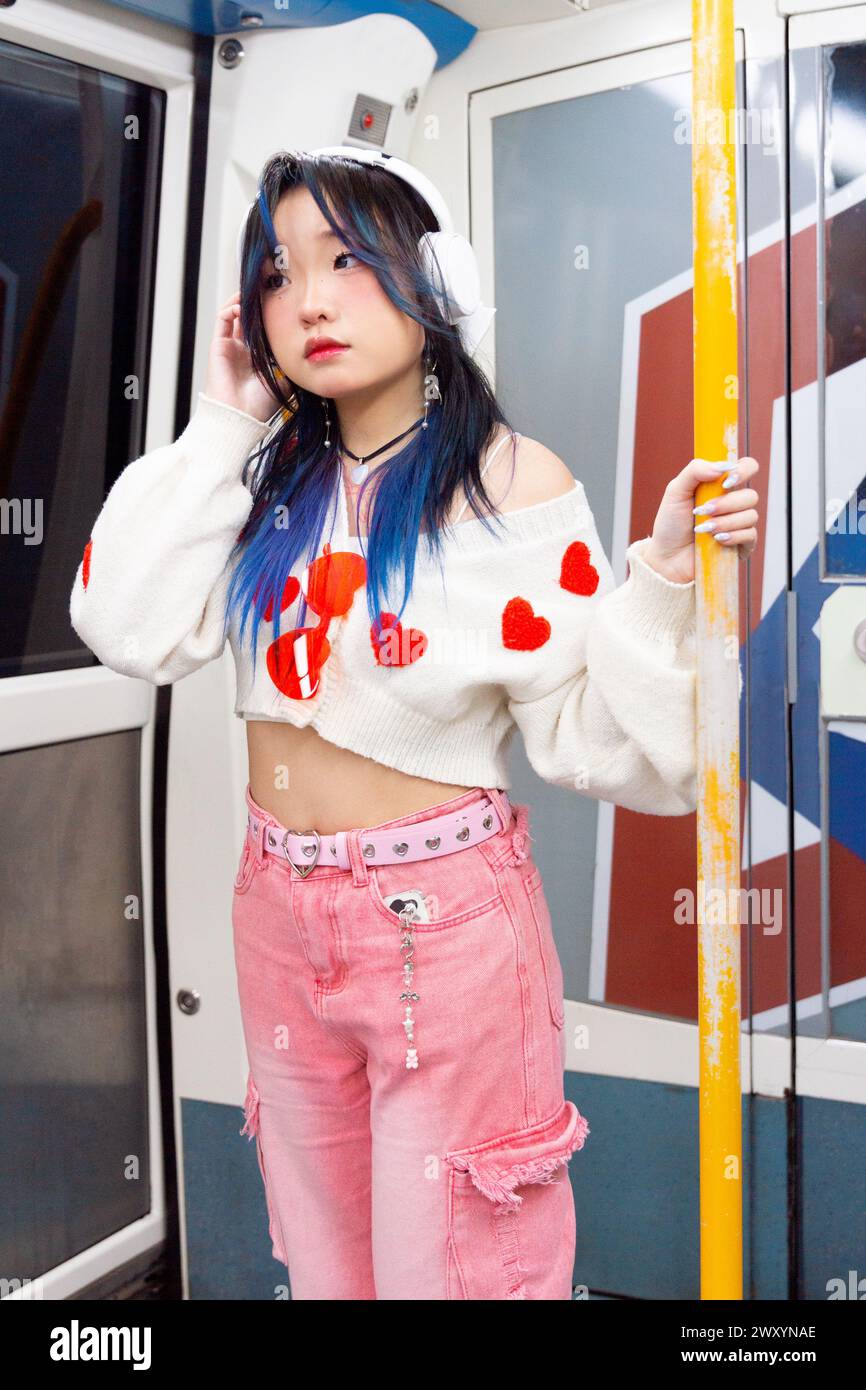 Fashion-forward Gen Z chinese girl with vibrant blue hair wearing ...