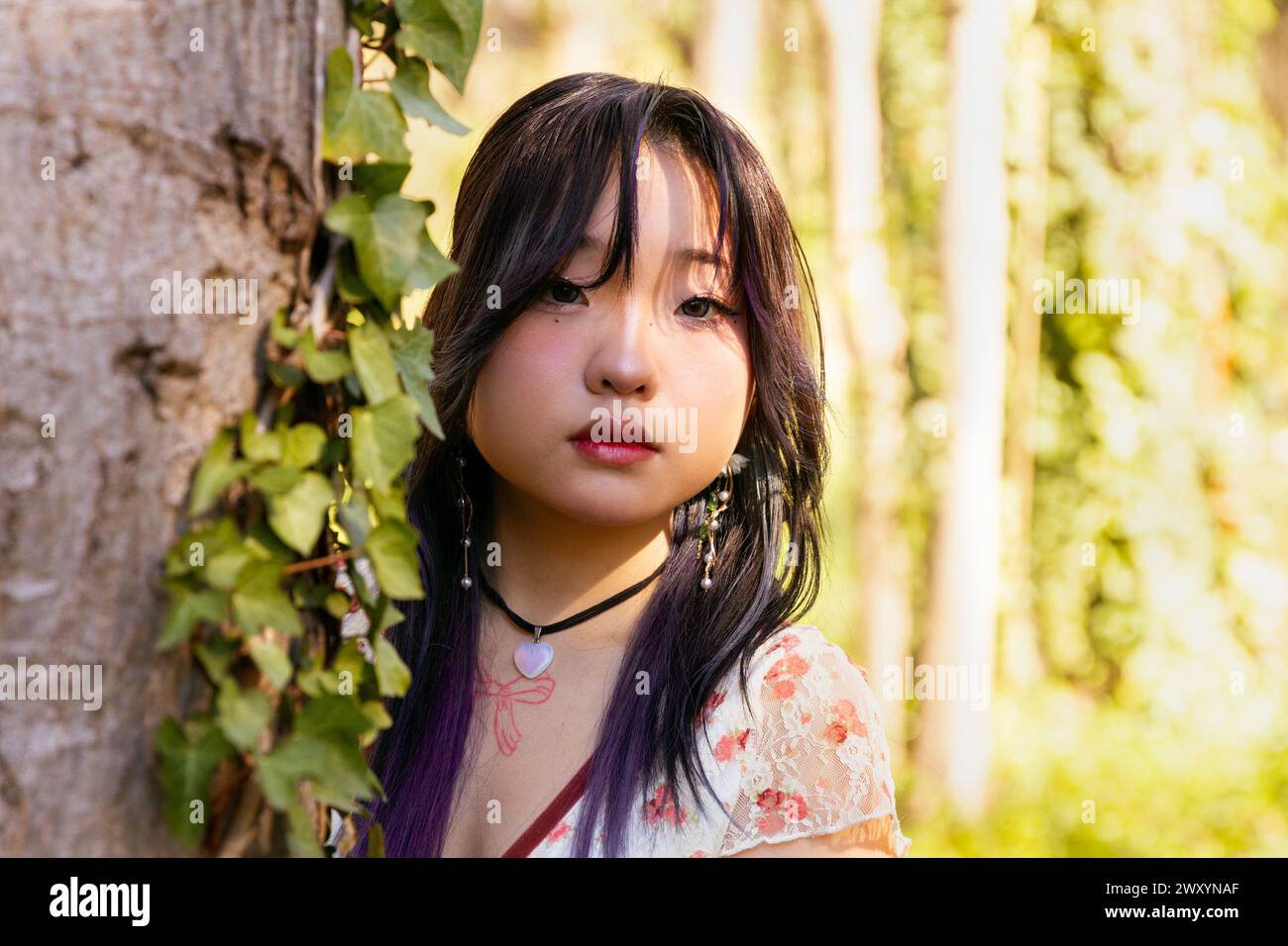 A portrait of a serene Asian Chinese woman with a subtle gaze, standing ...