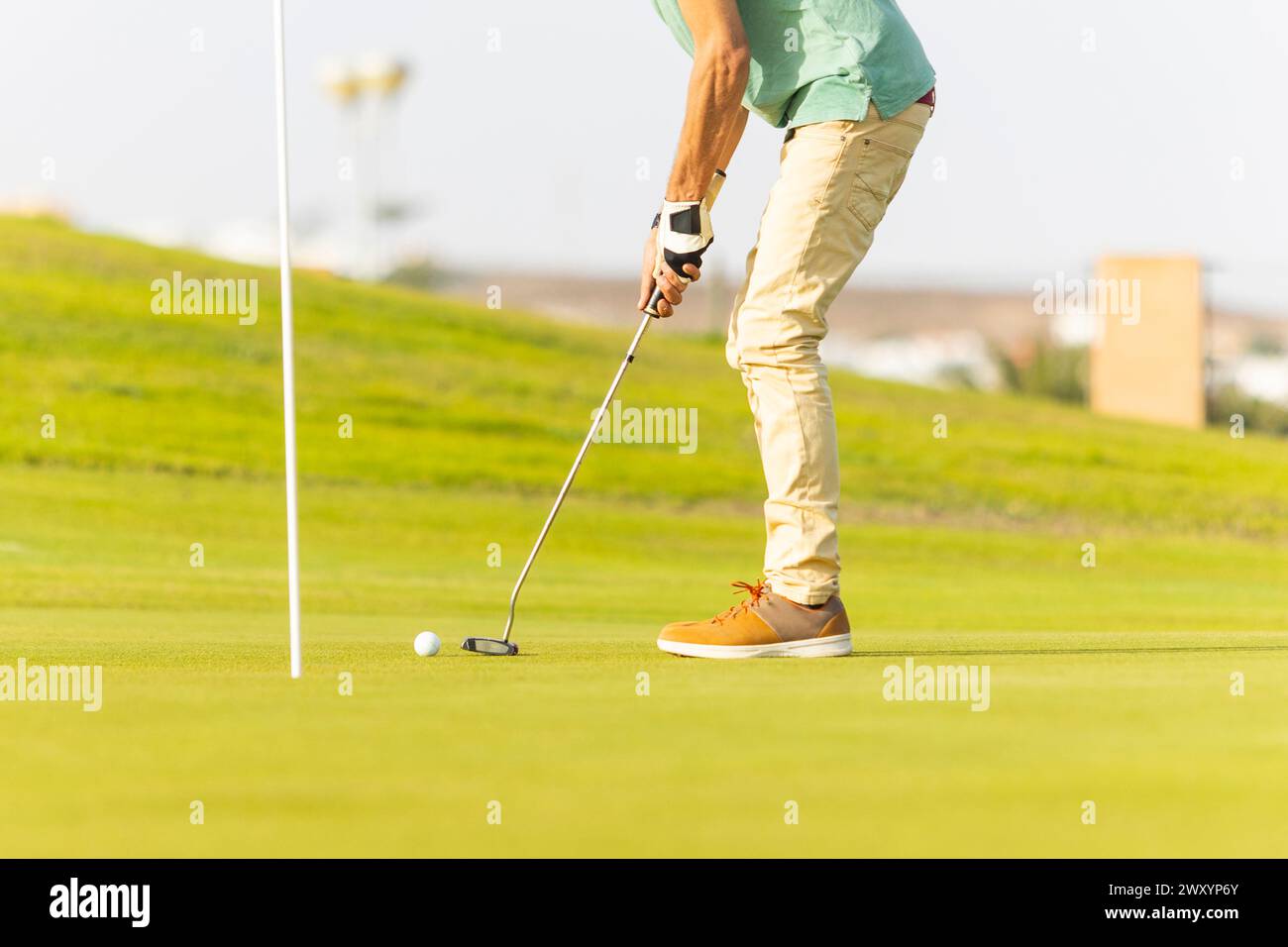 Cropped unrecognizable unique golfer with blonde dreadlocks poised for ...
