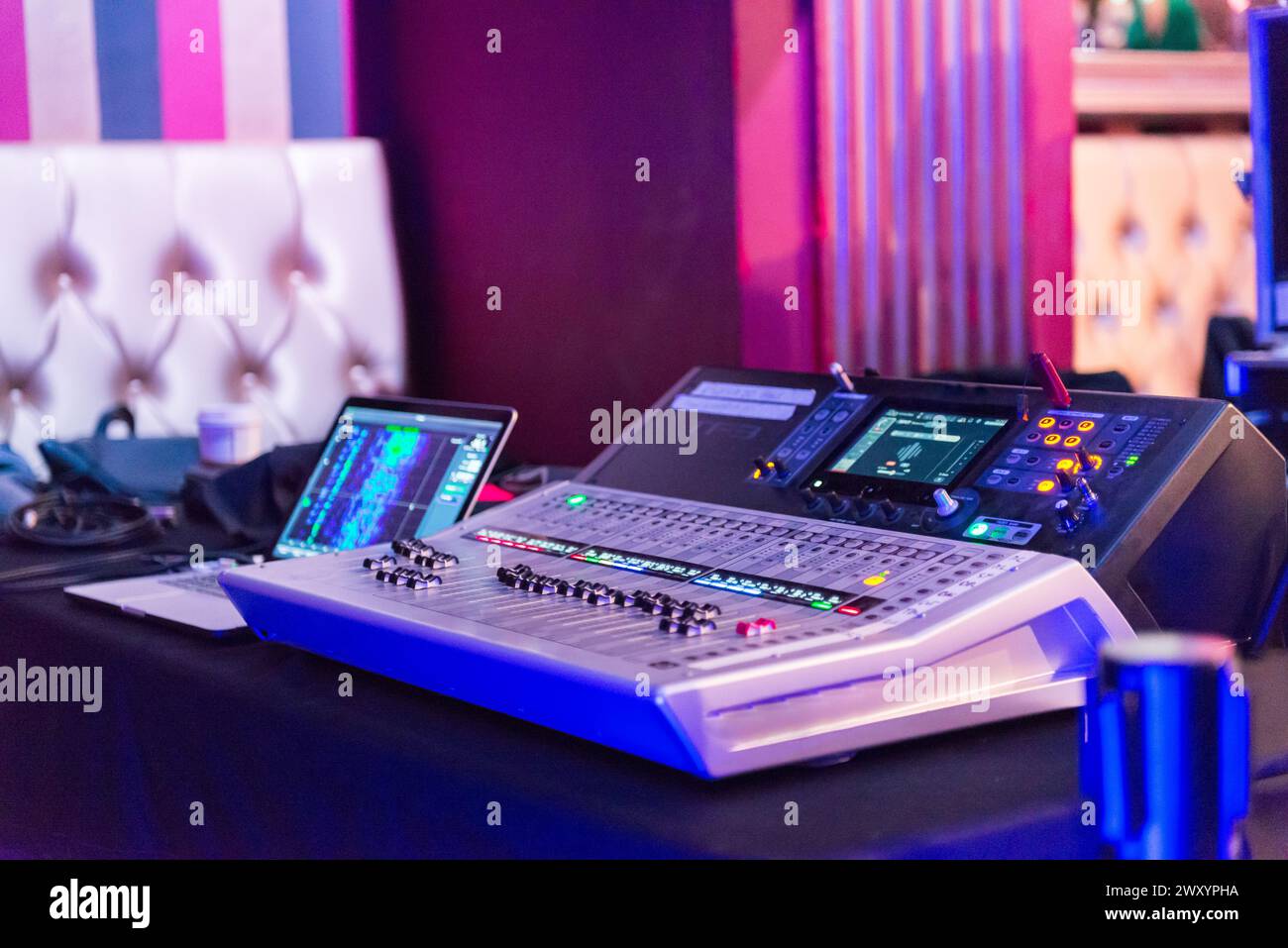 Professional audio mixing console equipped with multiple sliders and ...