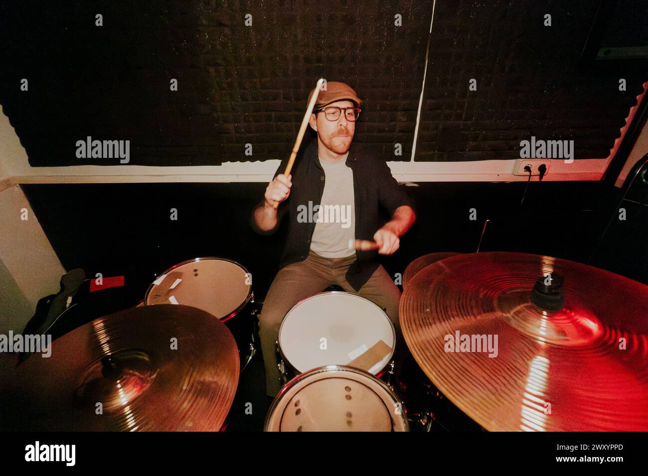 Male drummer in action, playing on a drum set with passion and ...