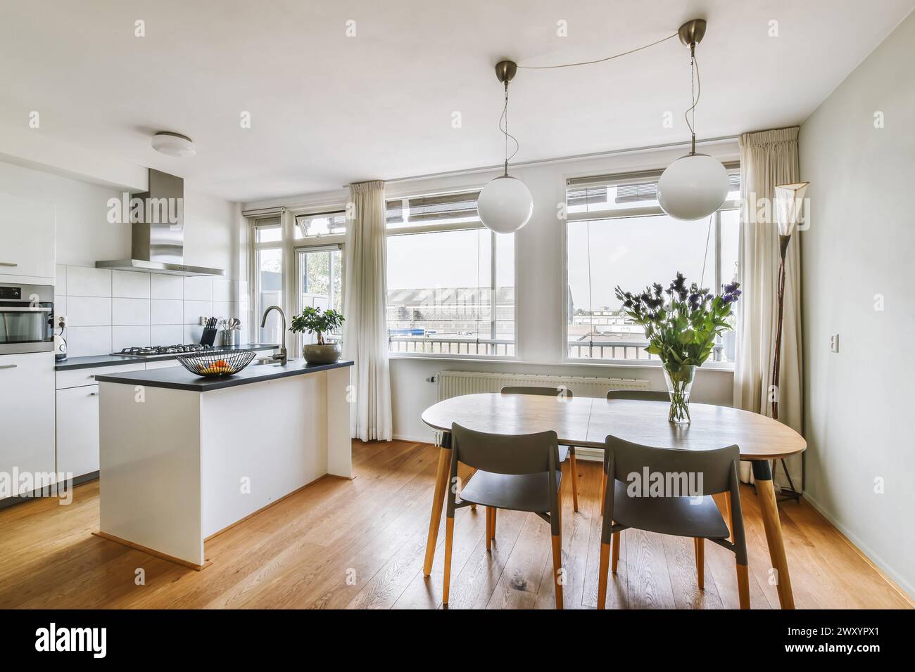 Bright modern kitchen with integrated dining space, showcasing ...