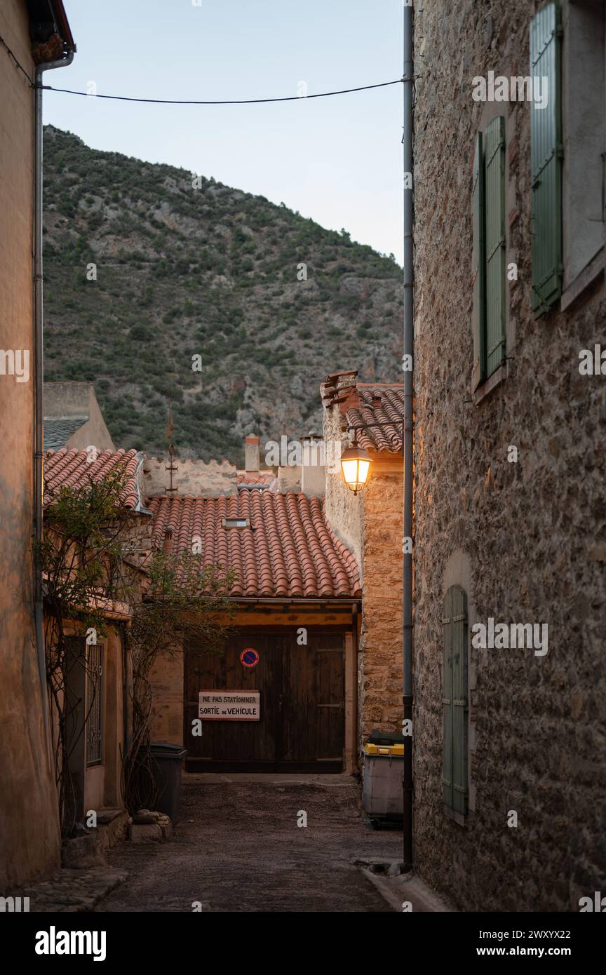 French alley of a typical village of Villefranche de Conflent at sunset ...