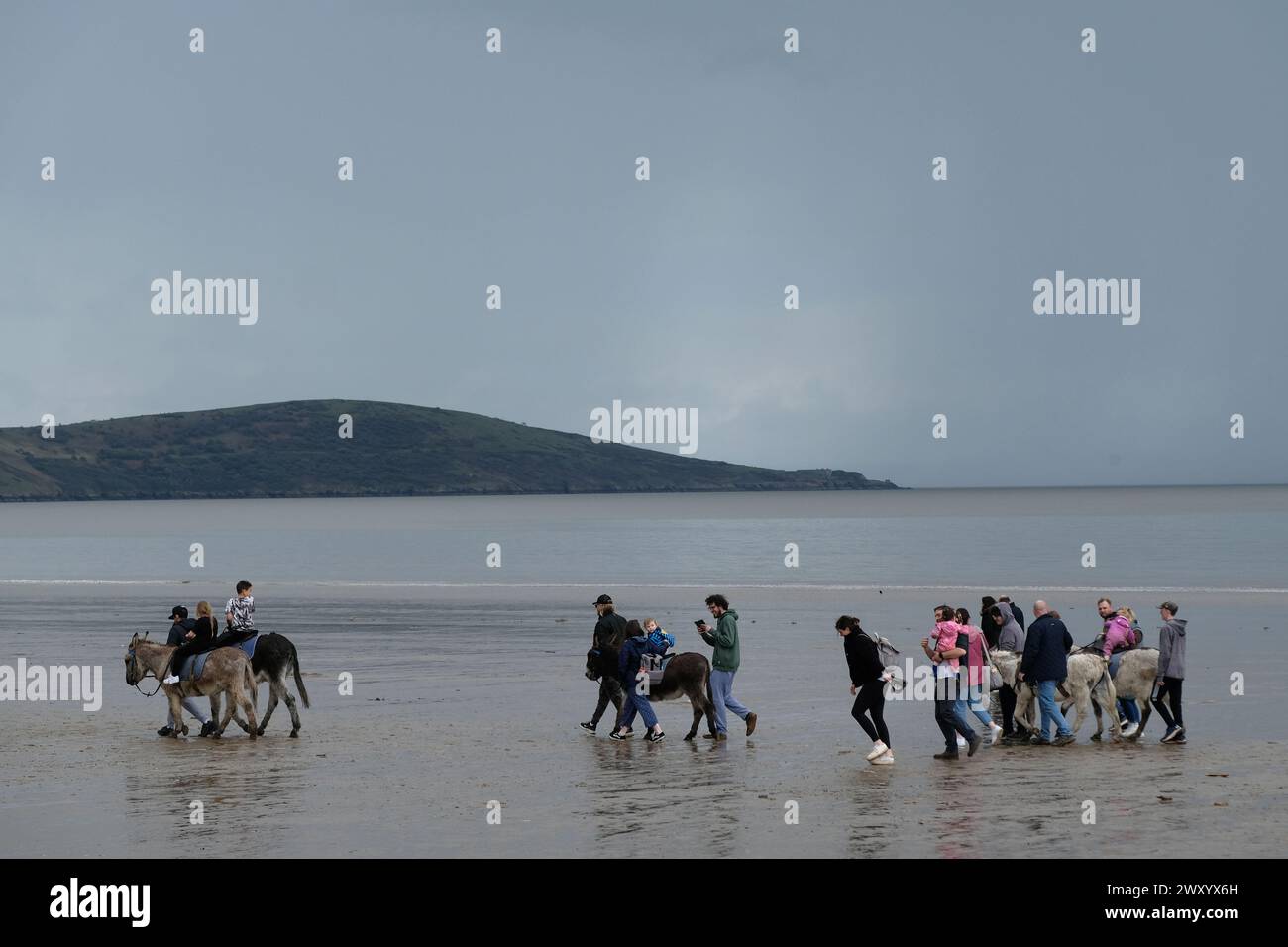 People walking on a cold, wet, windy, rainy beach Stock Photo - Alamy