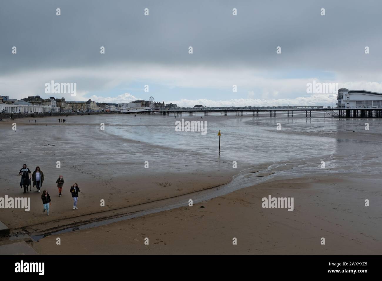 People walking on a cold, wet, windy, rainy beach Stock Photo - Alamy