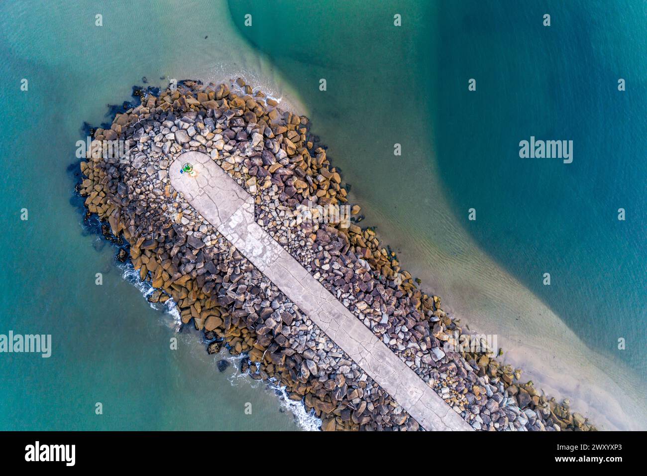 Aerial overhead view of a groyne on a beach, breakwater for coastal and ...