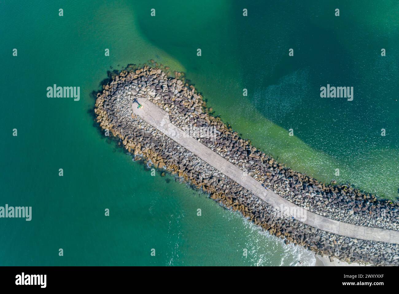 Aerial top view of a groyne on a beach, breakwater for coastal and ...