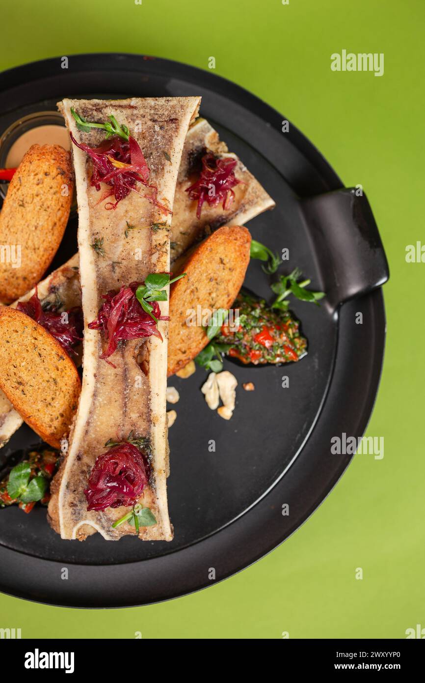 Roasted bone marrow with buttery richness on crusty bread, garnished ...