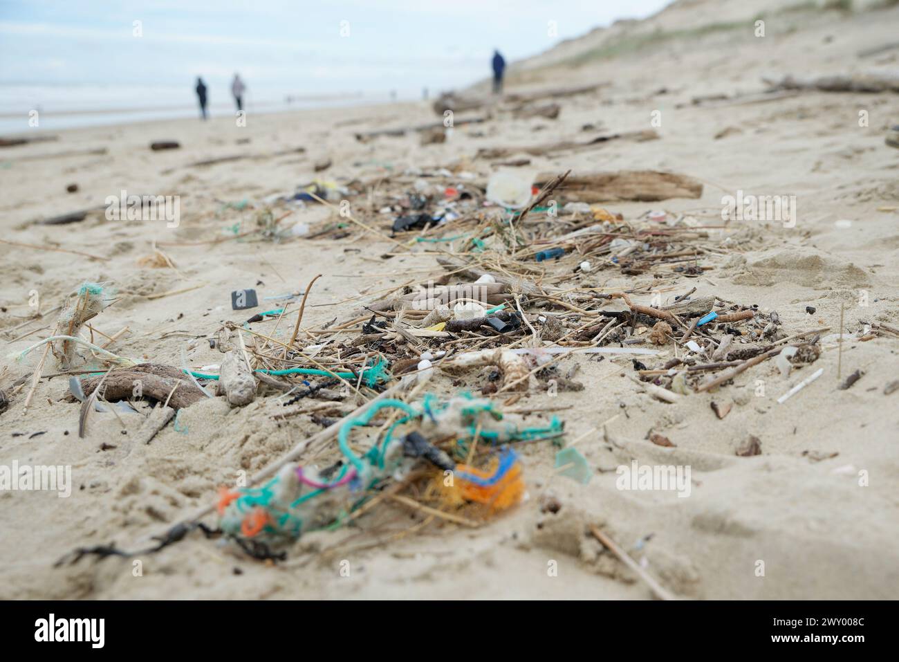 Plastic waste and various objects on the sand by the beach. Trash on ...