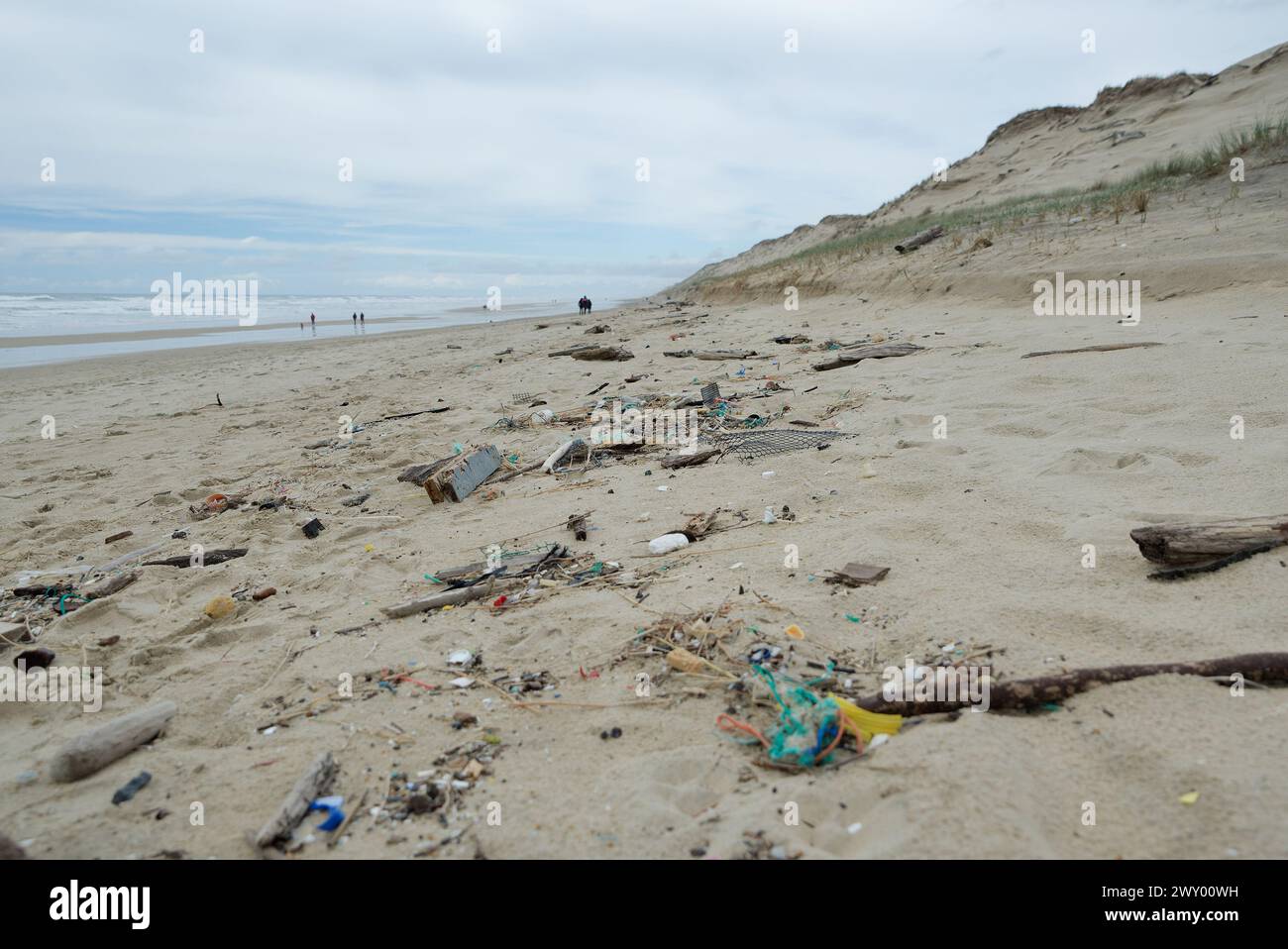 Plastic waste and various objects on the sand by the beach. Trash on ...