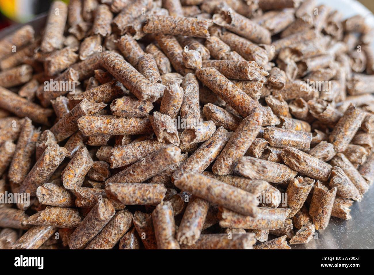 A pile of organic wooden pellets made from compacted sawdust of ...
