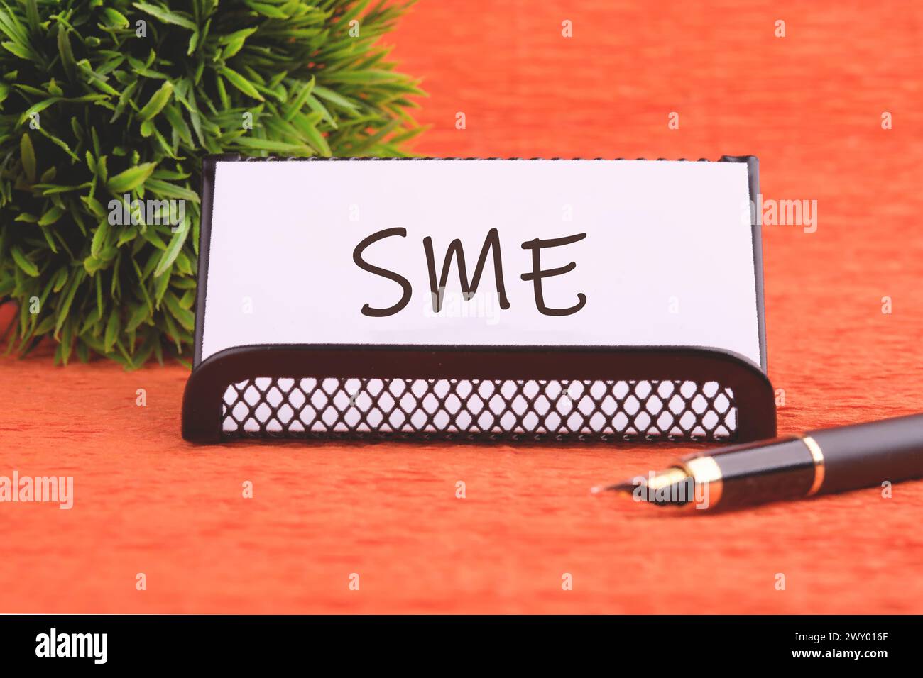 SME (or small and medium enterprises) symbol on a white business card ...