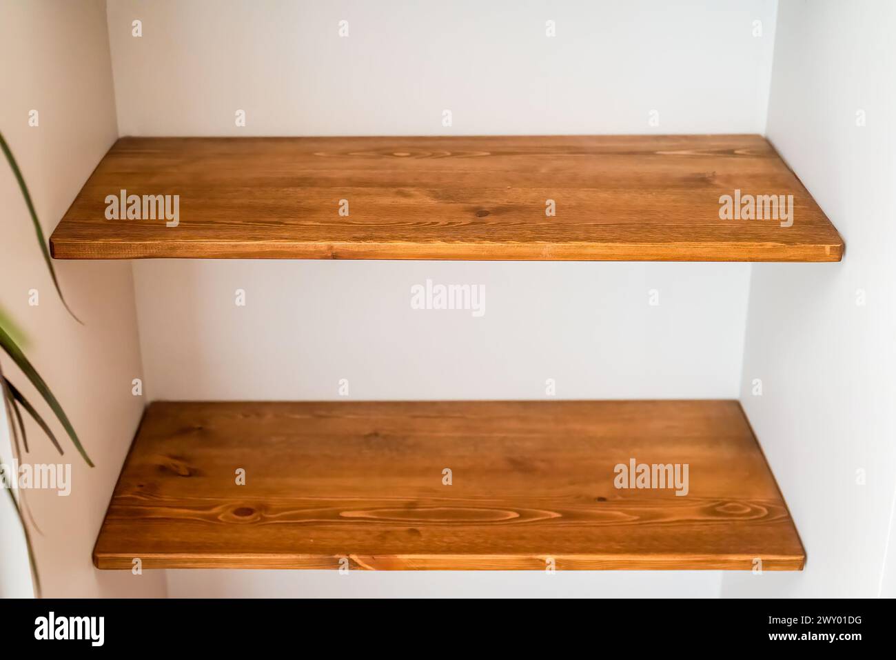 two empty wooden shelves on a white wall Stock Photo - Alamy