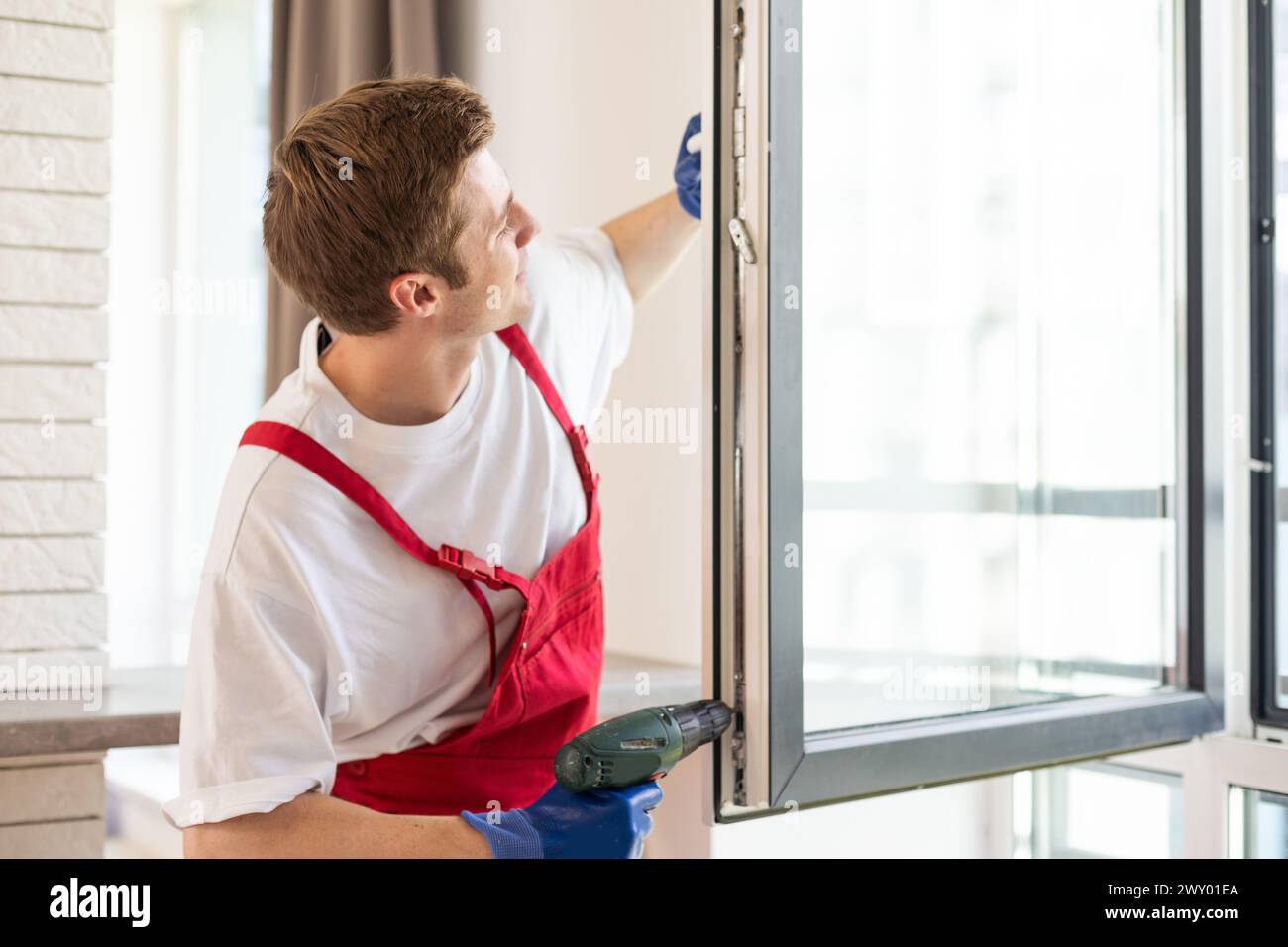 Construction worker installing window in house Stock Photo - Alamy