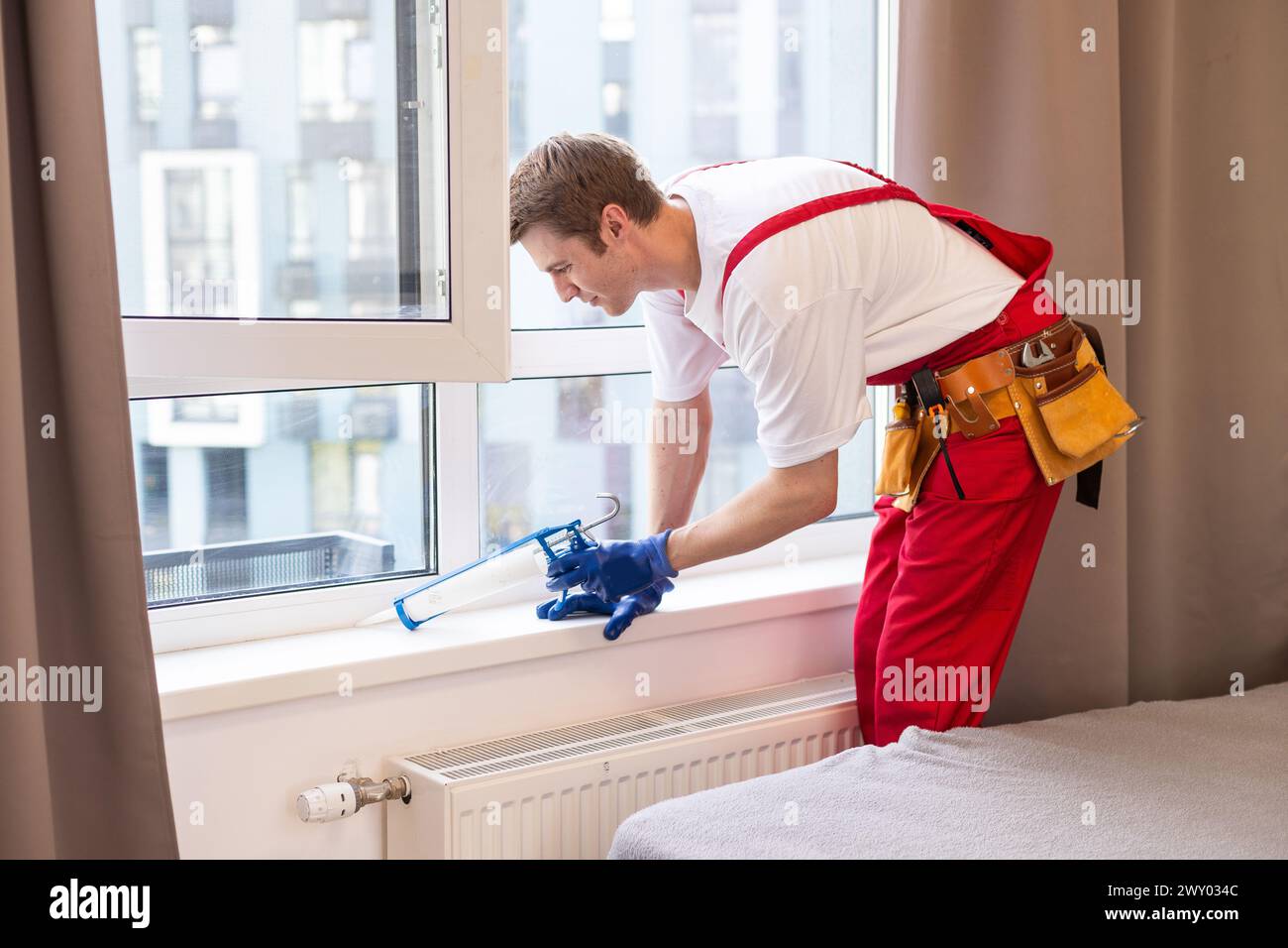Construction worker installing window in house Stock Photo - Alamy